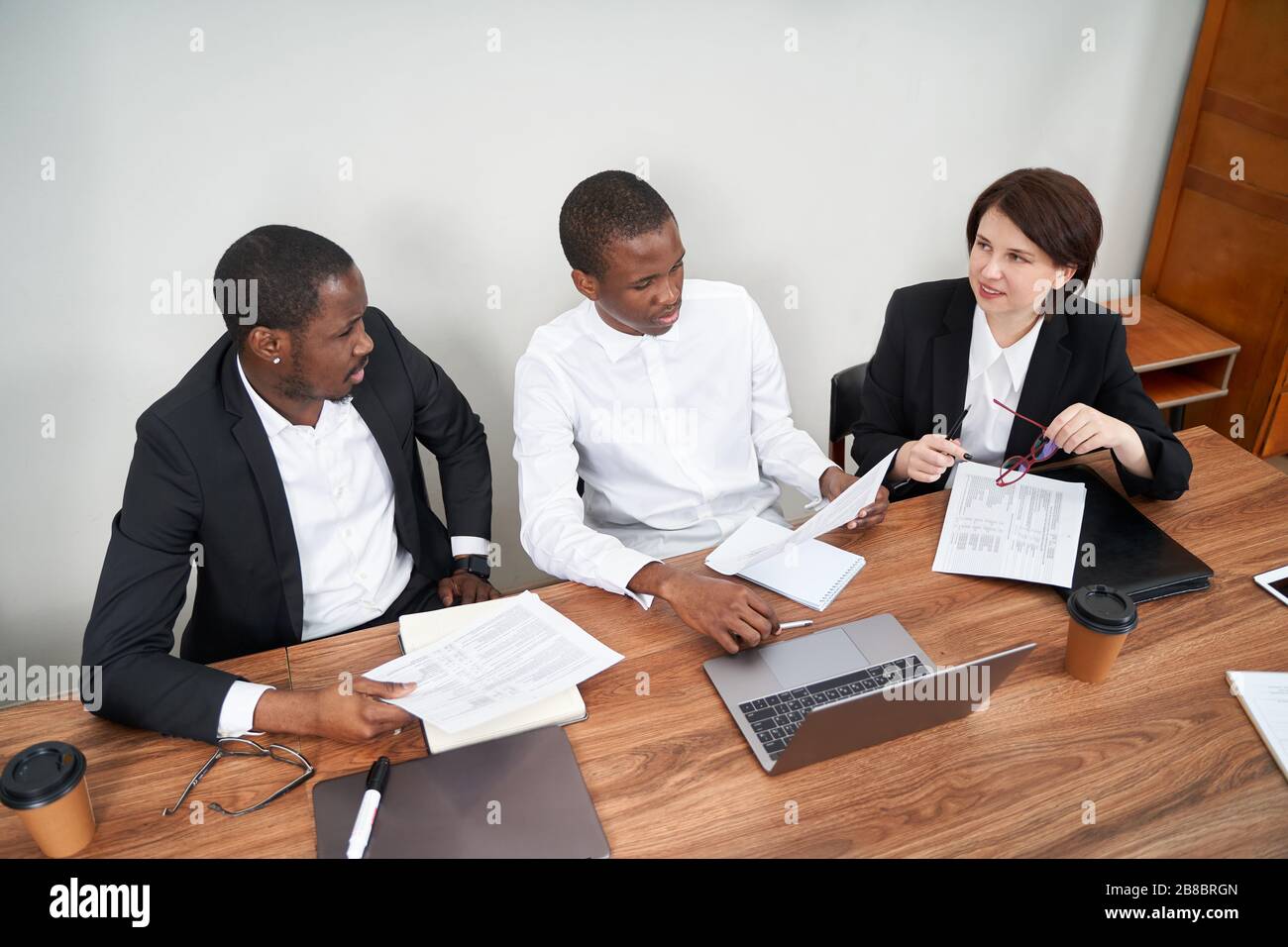 Young happy business people working together in modern office ...