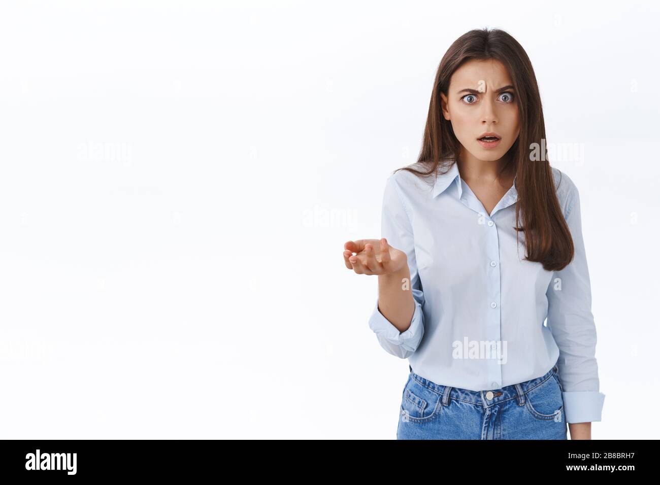 Confused woman pointing at something strange. Shocked speechless female ...