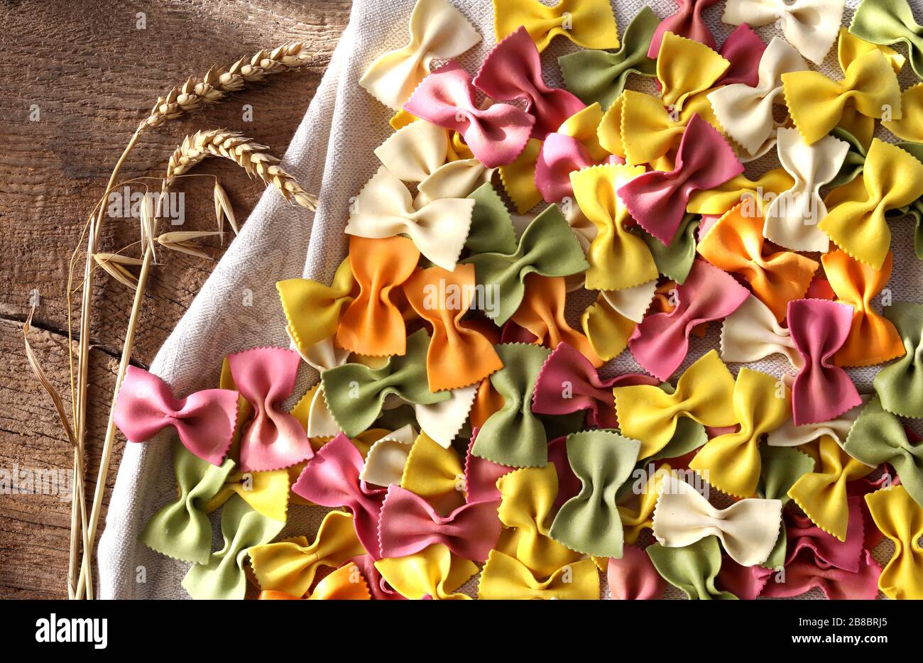 Colorful Italian pasta spaghetti with dry rye and oat on old wood ...