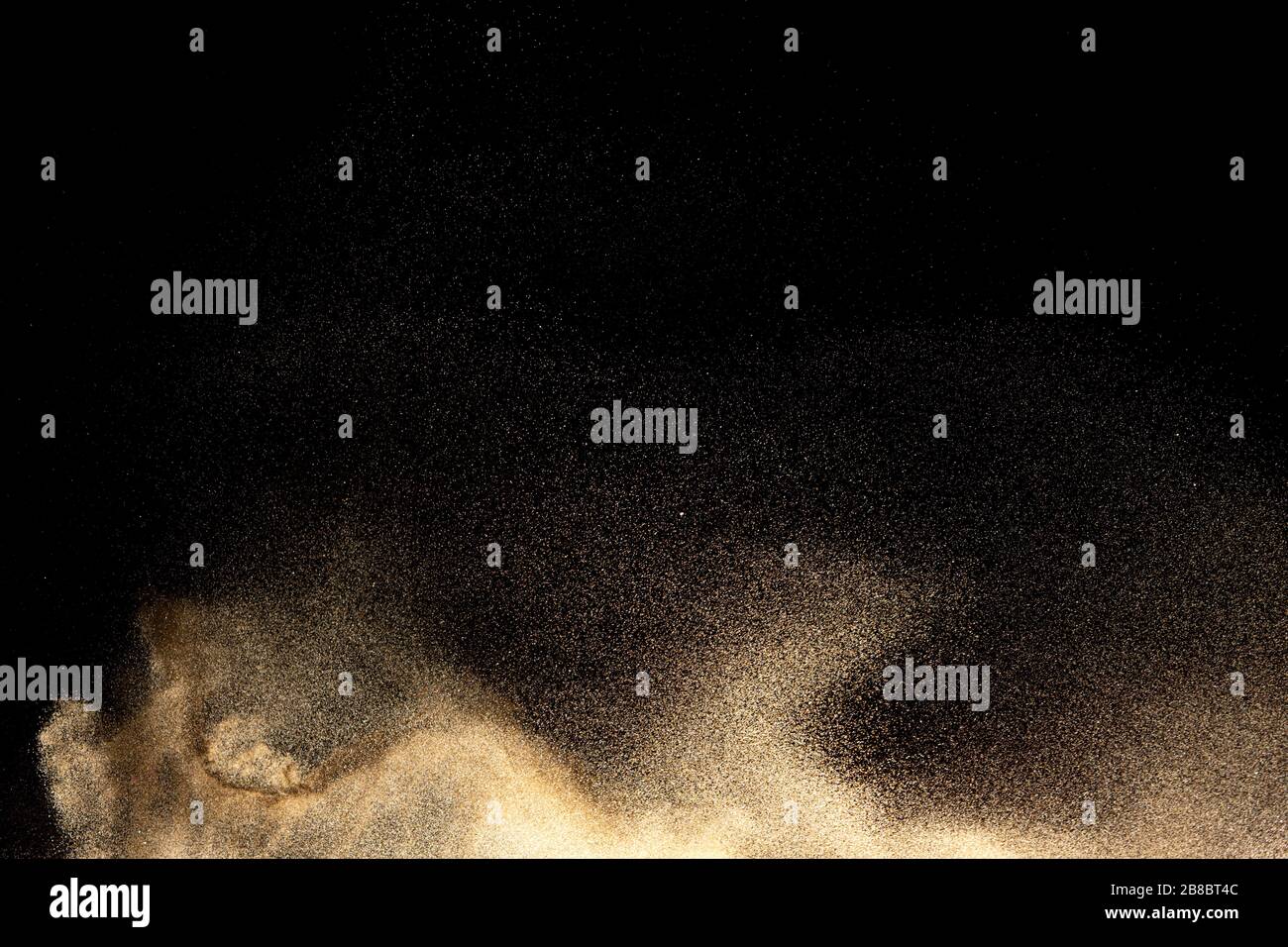 Brown colored sand splash.Dry river sand explosion isolated on black ...