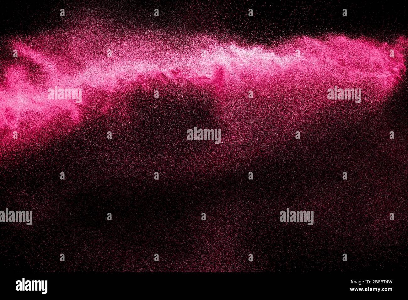 Pink powder explosion on black background.Pink dust splash cloud on ...