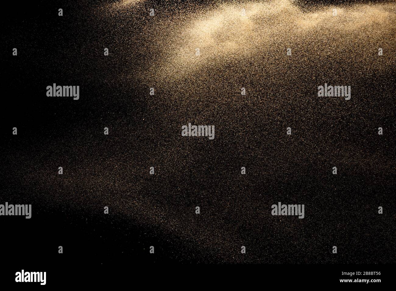 Brown colored sand splash.Dry river sand explosion isolated on black ...