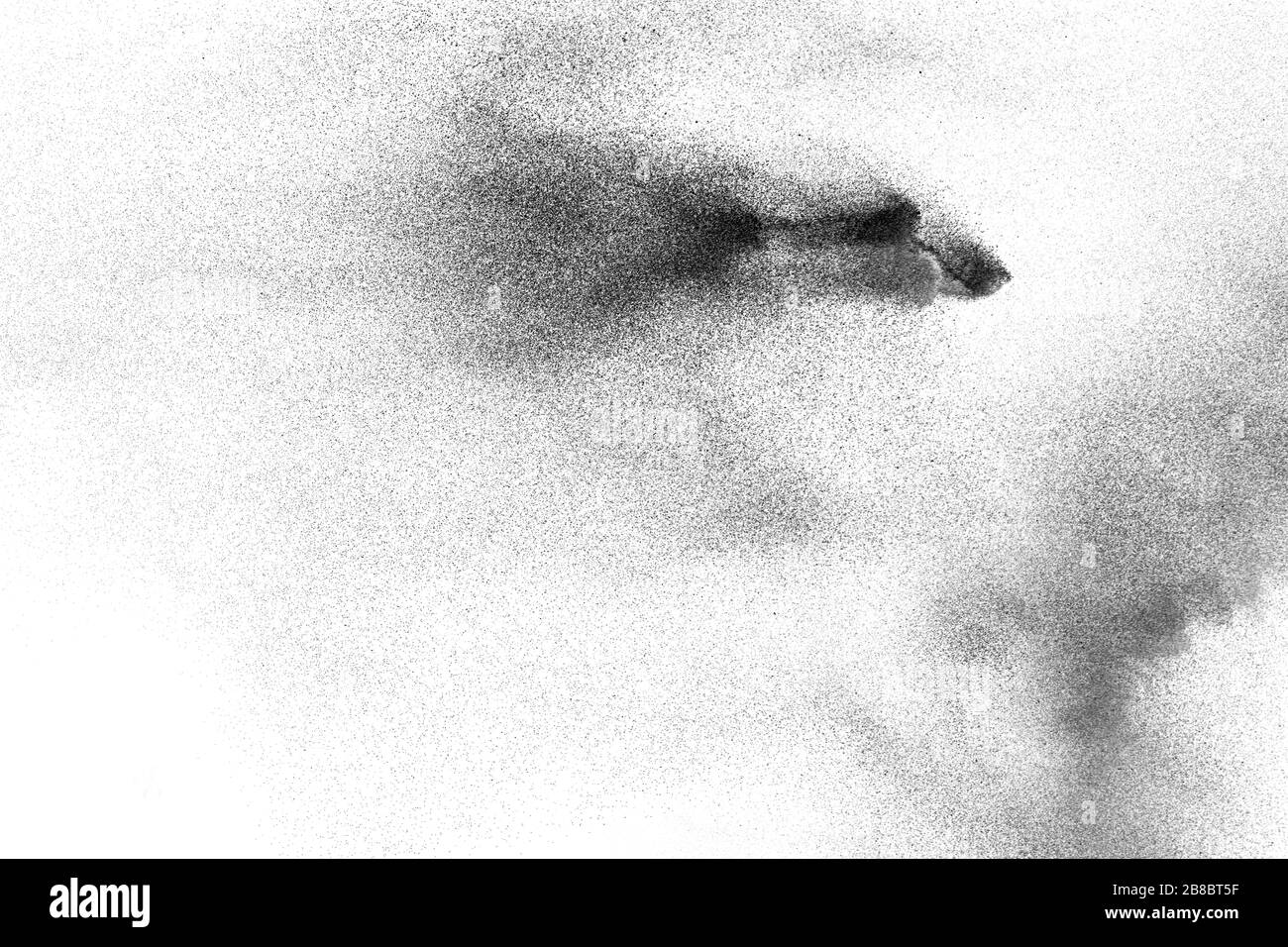 Black powder explosion on white background.Black dust particles splash ...