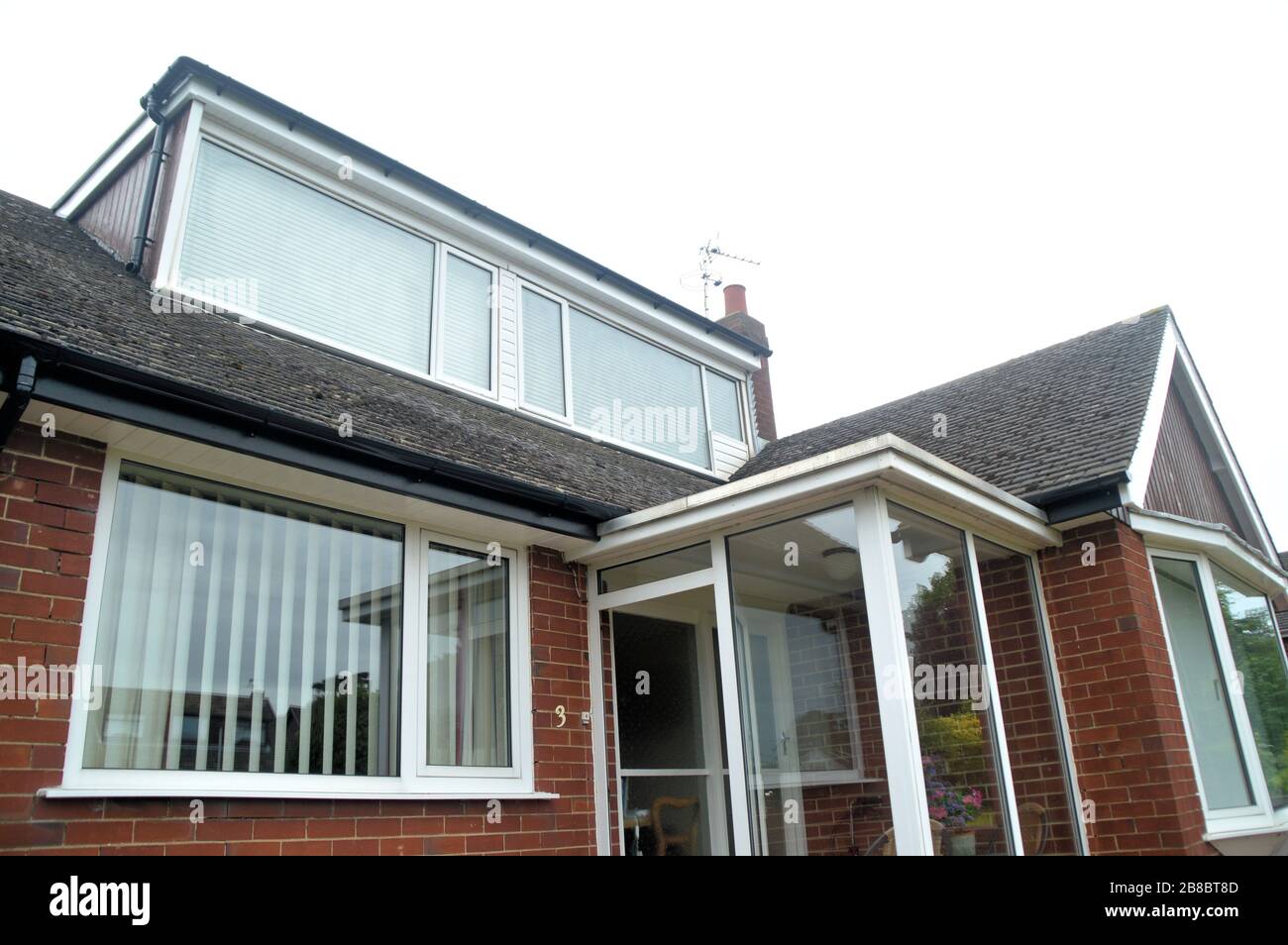 Small detached house with big windows Stock Photo - Alamy
