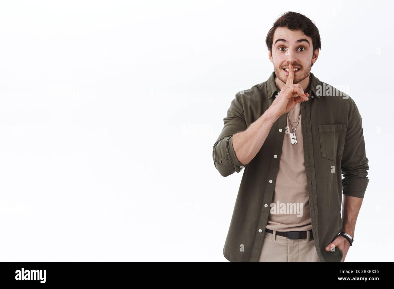 Handsome happy guy prepare surprise for girlfriend, asking keep silent ...