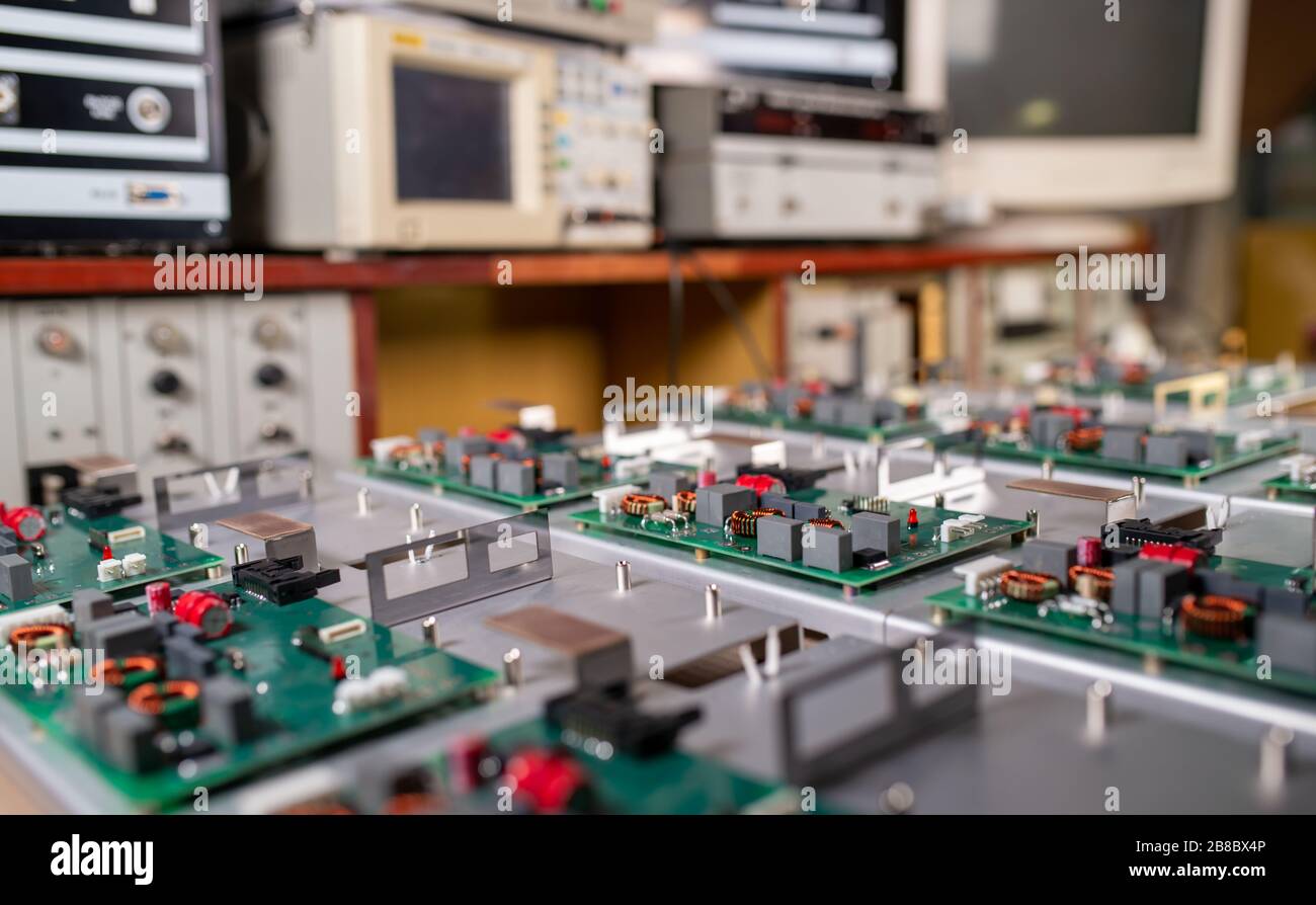 Microcircuits and components lie on metal plates during the production ...