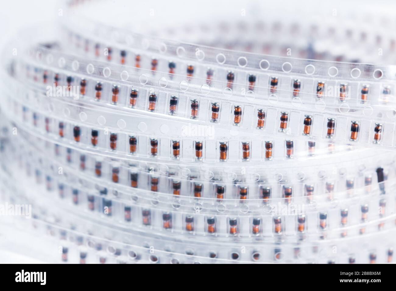 Photo of electrical part plastic tape with capacitors for electronic ...