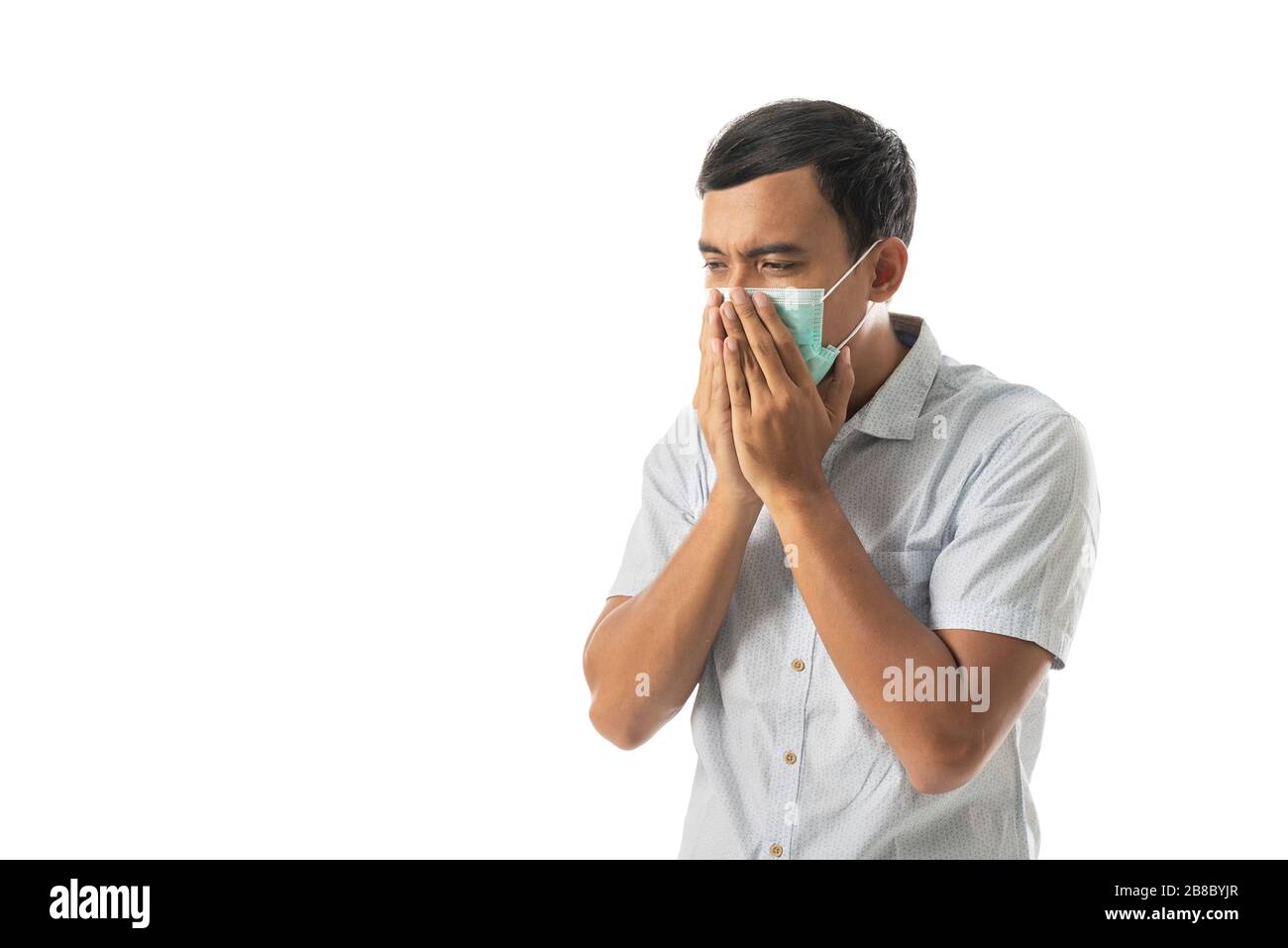 man wearing face masks and coughing isolated over white background ...