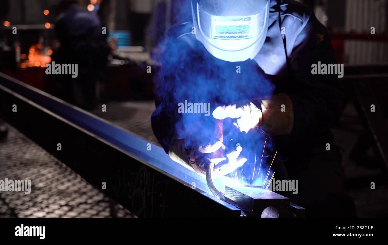 The work of the welder. Welding work in the factory floor Stock Photo ...
