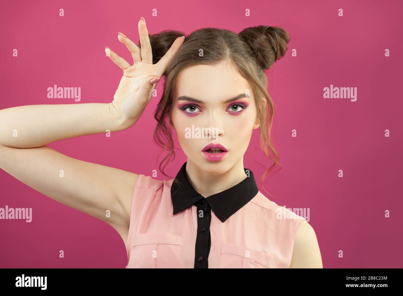 Pretty model woman with fashion makeup on bright pink background Stock ...