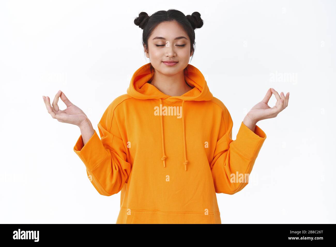 Patience is key. Happy and calm, relaxed smiling asian girl meditating ...