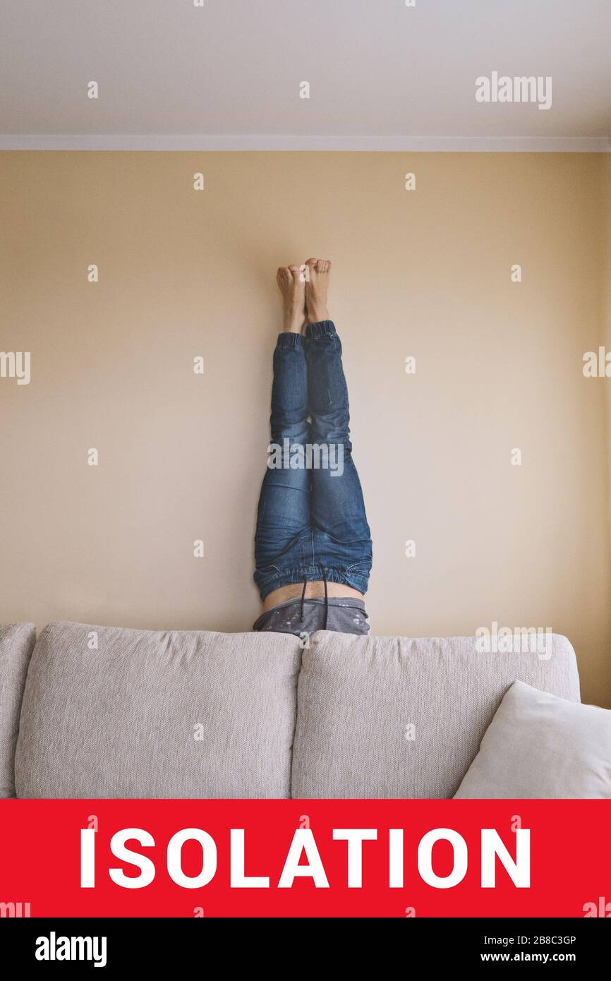 Man handstanding behind couch. People goes crazy in quarantine. Men's ...