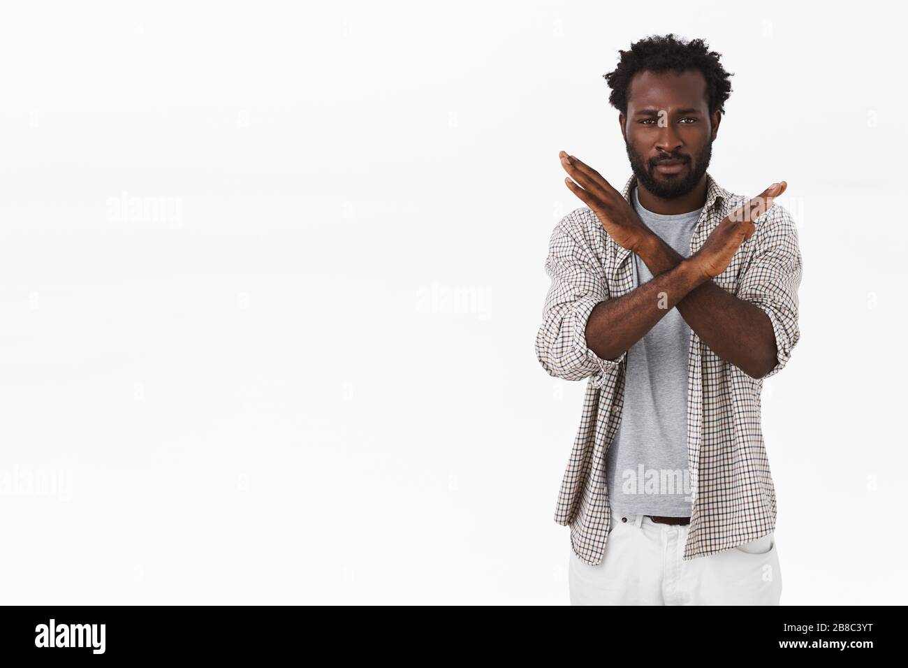 Reluctant and displeased young african-american bearded guy making ...