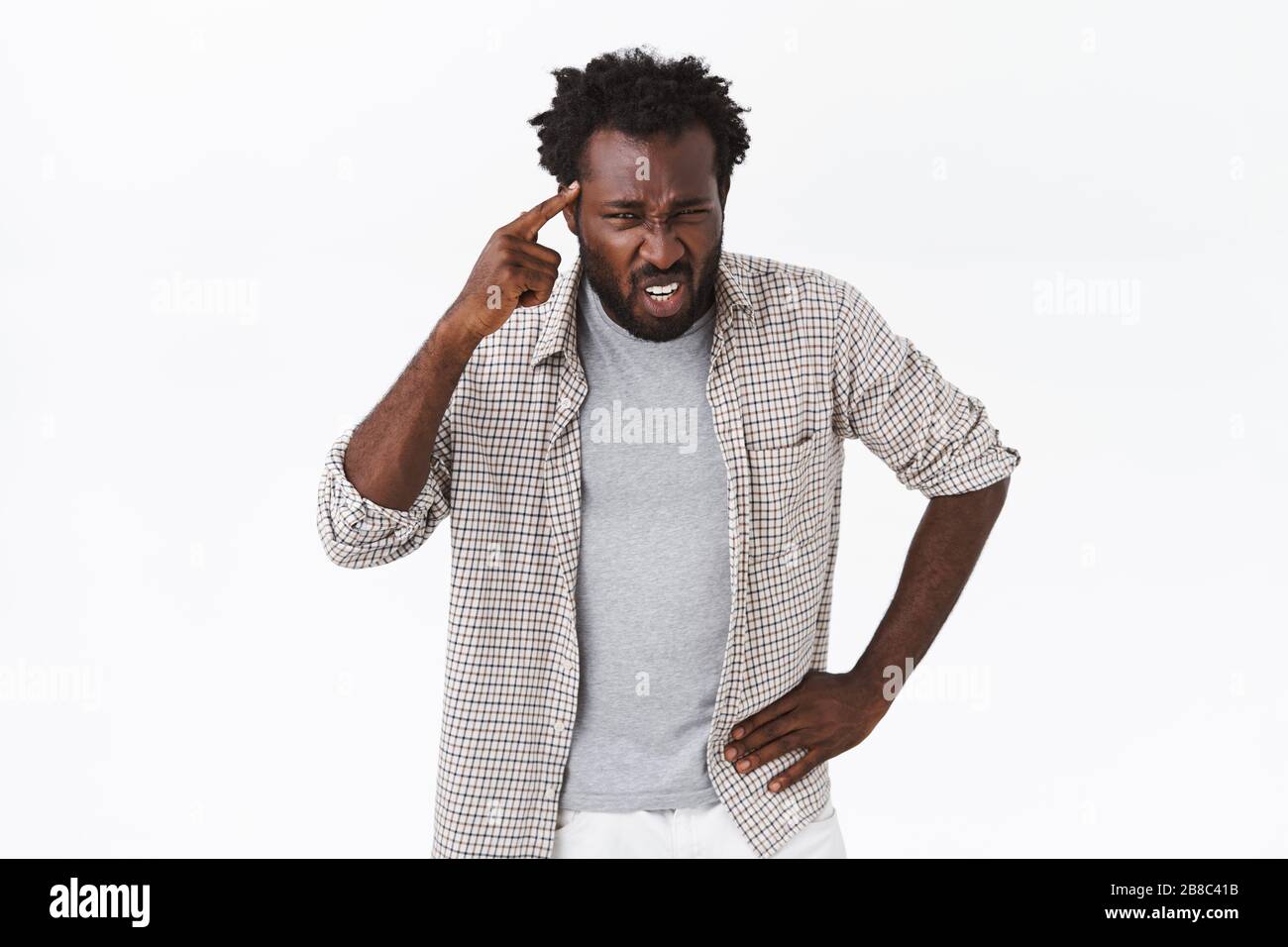 Annoyed and angry guy arguing, scolding someone being without brains ...