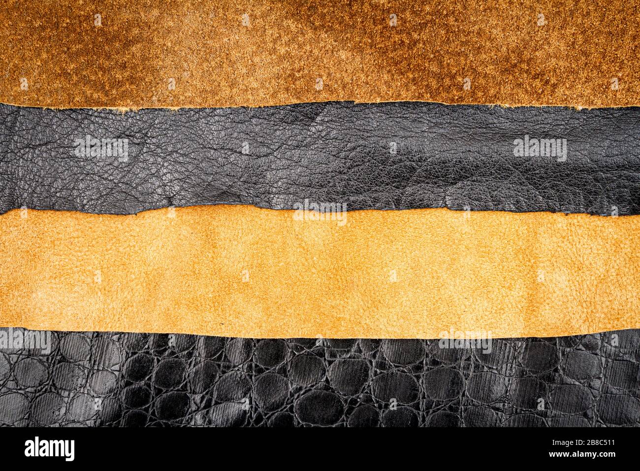 Brown and black leather and artificial alligator skin textures ...