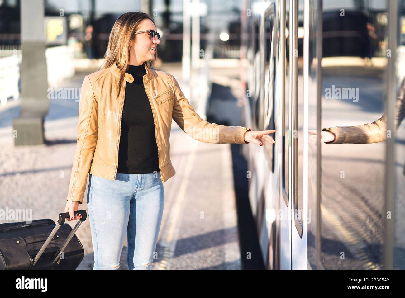 Woman going inside the train. Passenger pushing the button to open door ...