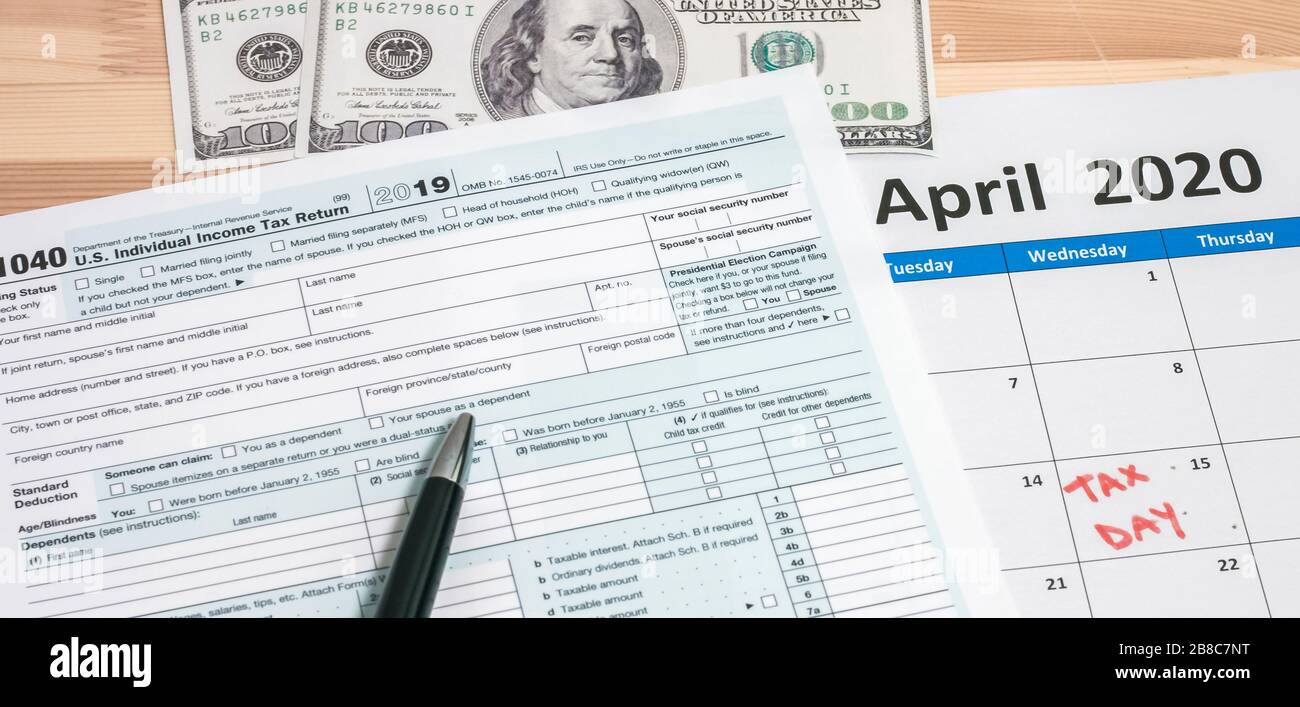 US 1040 tax return form with 100 usd dollar bills and calendar Stock ...