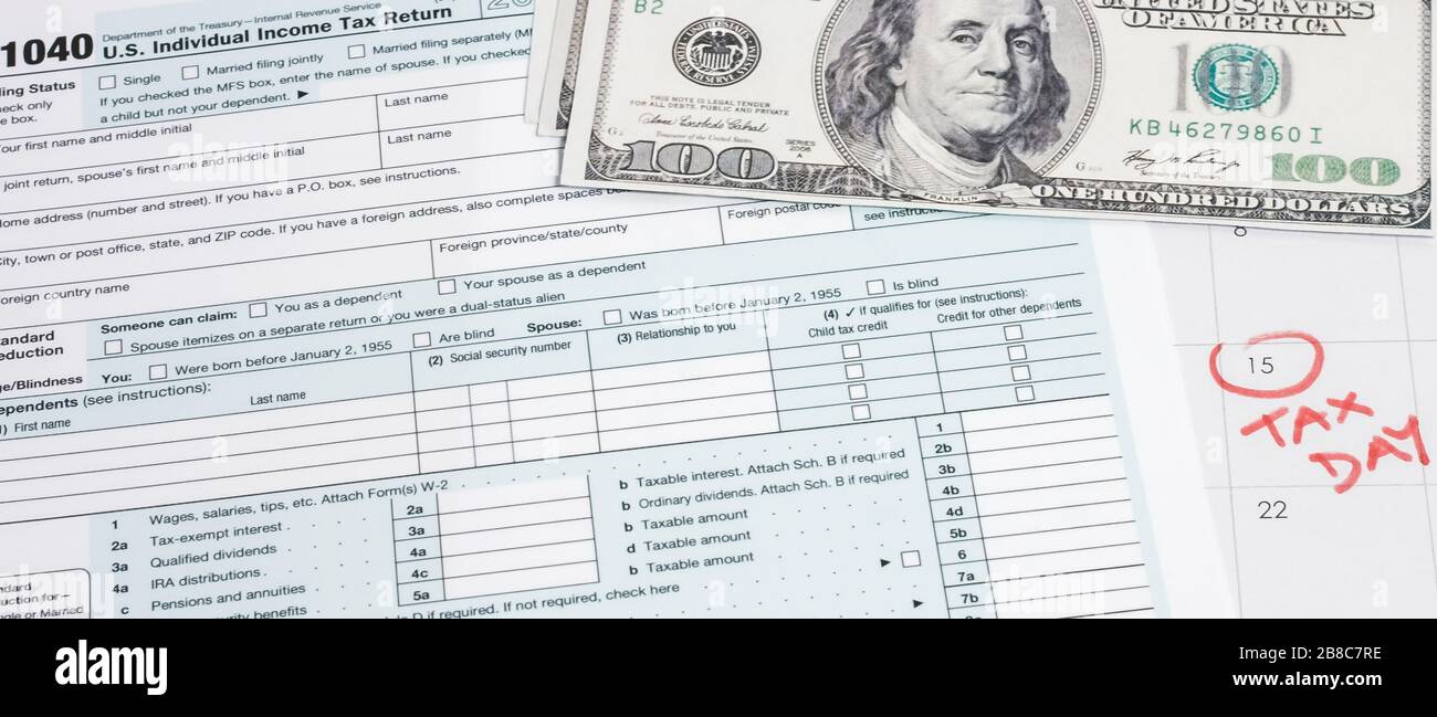 US 1040 tax return form with 100 usd dollar bills and calendar Stock ...