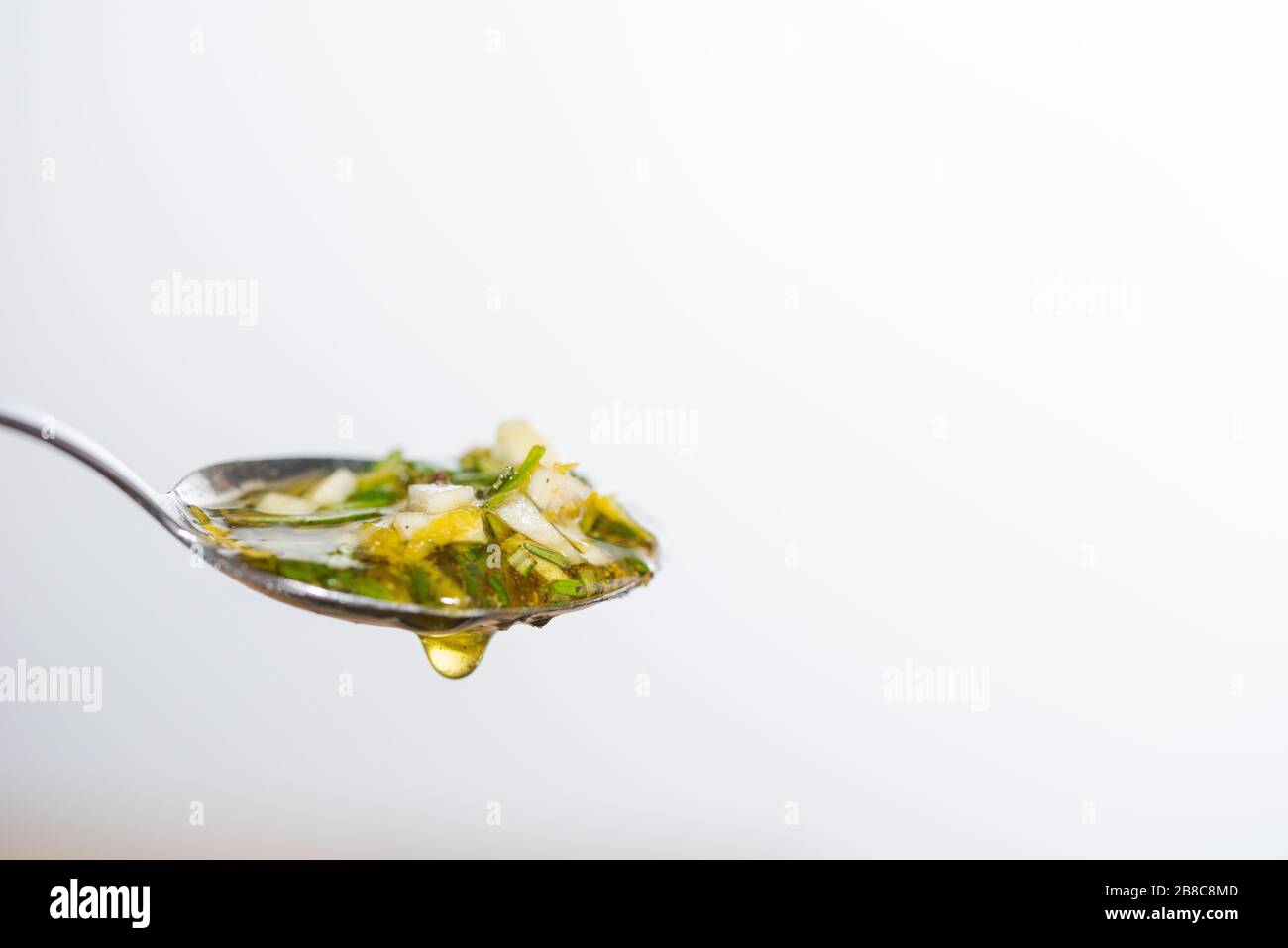 Detail of barbecue marinade on small spoon with white background Stock ...