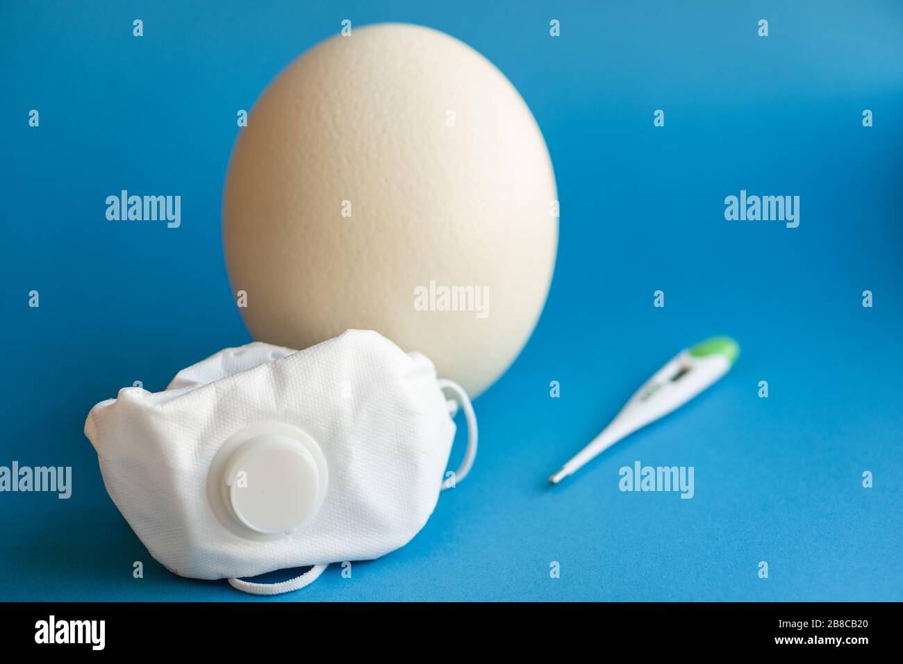 Large white easter ostrich egg in a respirator and a thermometer. Egg ...