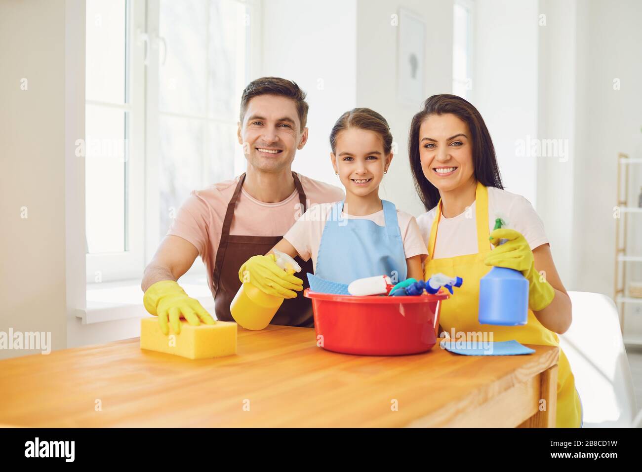 Happy family cleans the room in the house. Mother father and little ...