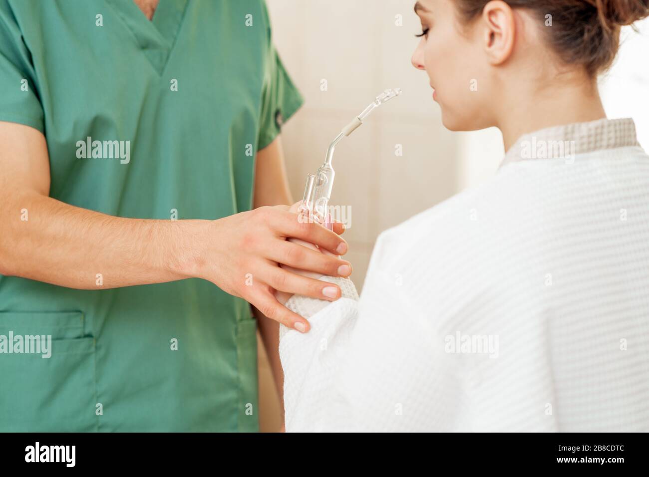 Woman receives nasal inhalation Maholda by essential oil in nose at spa ...