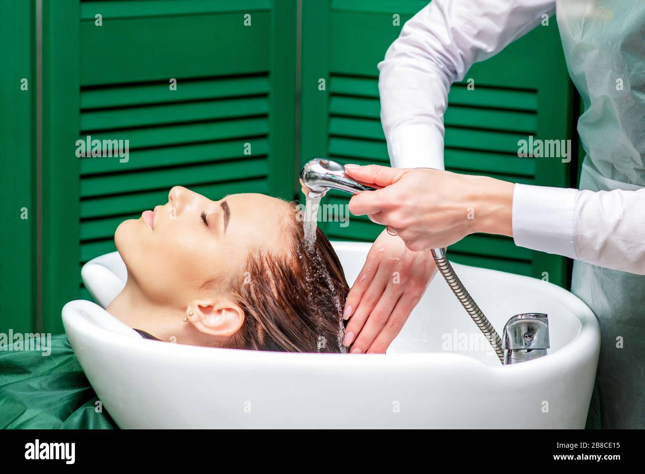 Woman receiving washing hair in sink at beauty salon Stock Photo - Alamy