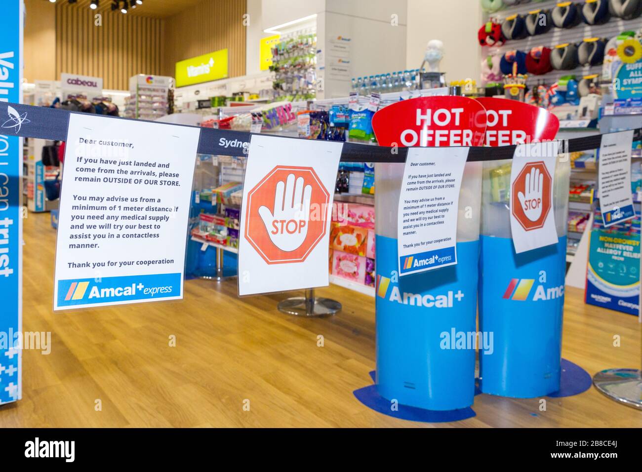 Coronavirus warning signs and safety barriers at an Amcal pharmacy at ...