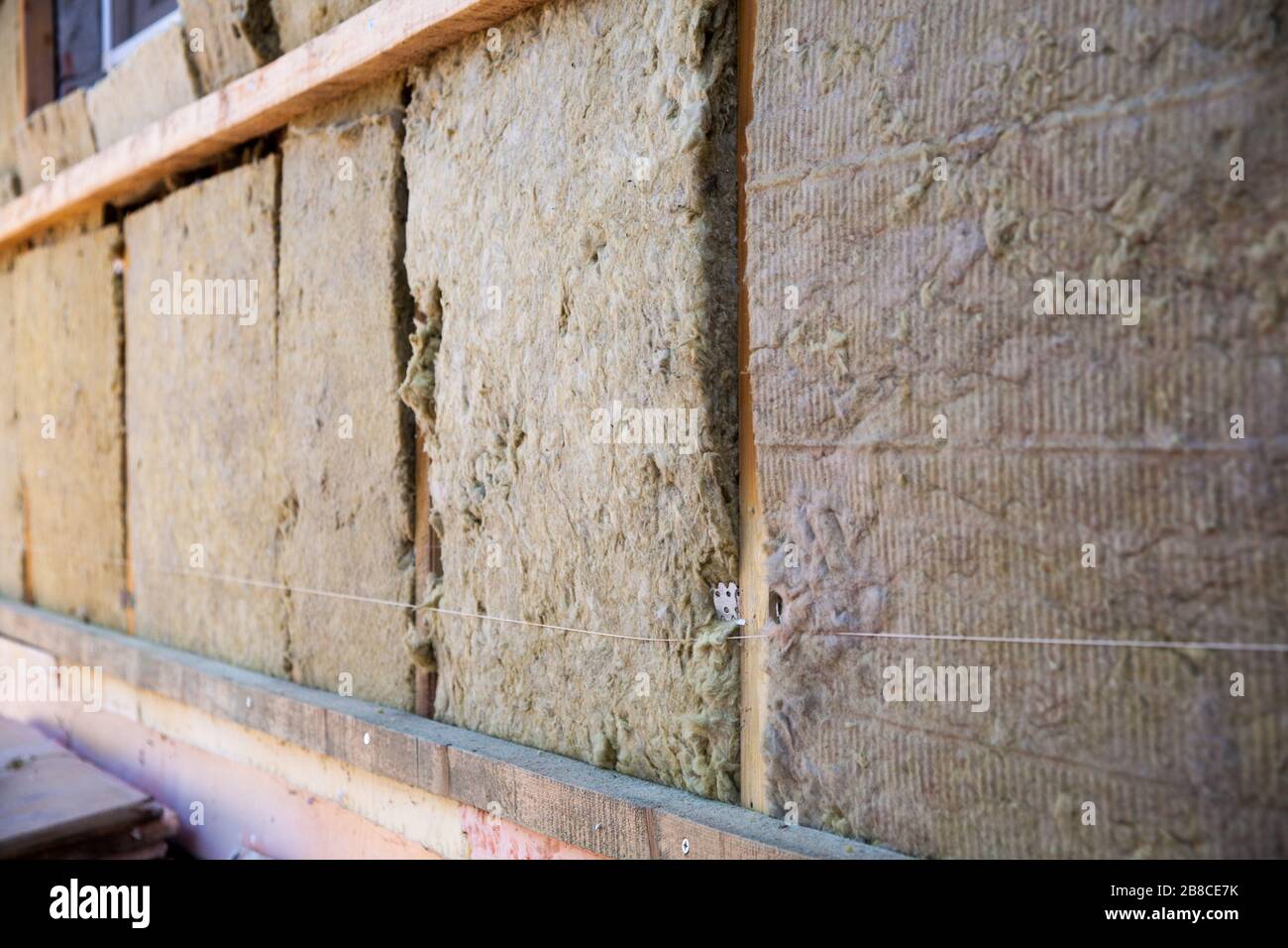 warming the walls of a stone house with a stone wool heater. Ecological ...
