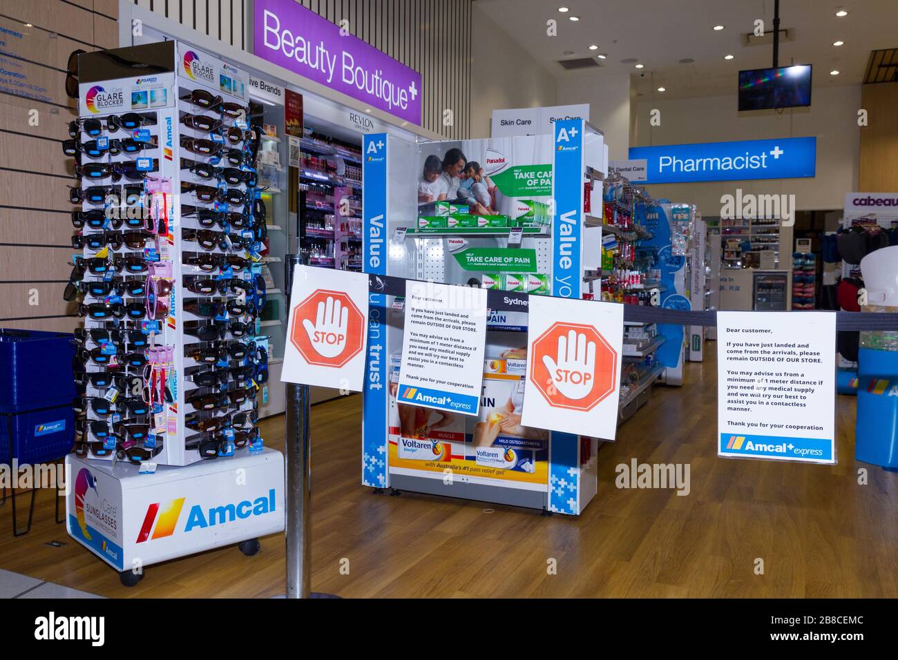 Coronavirus warning signs and safety barriers at an Amcal pharmacy at ...