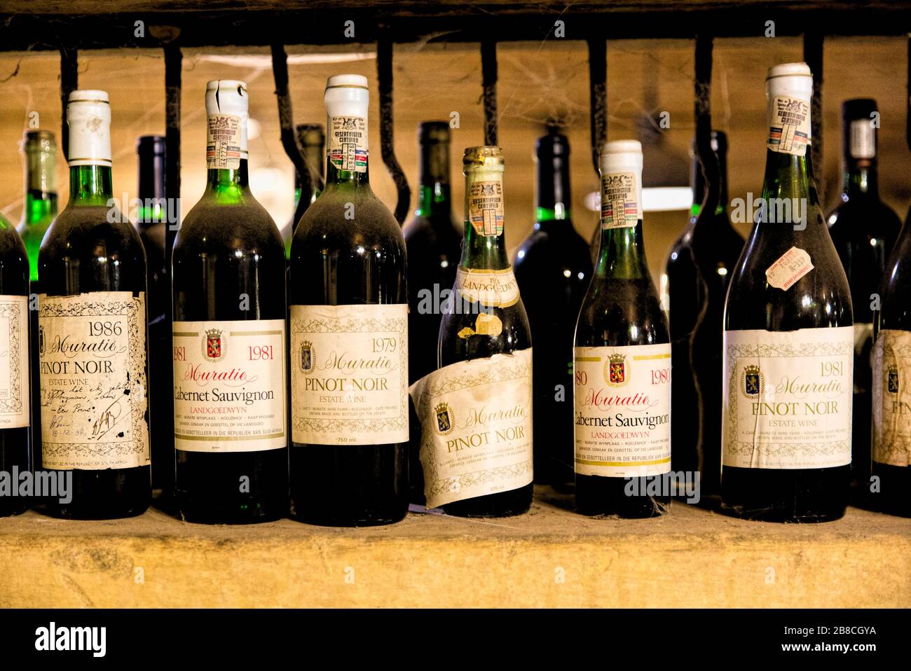 Row of vintage bottles of wine on display at Muratie Wine Farm ...