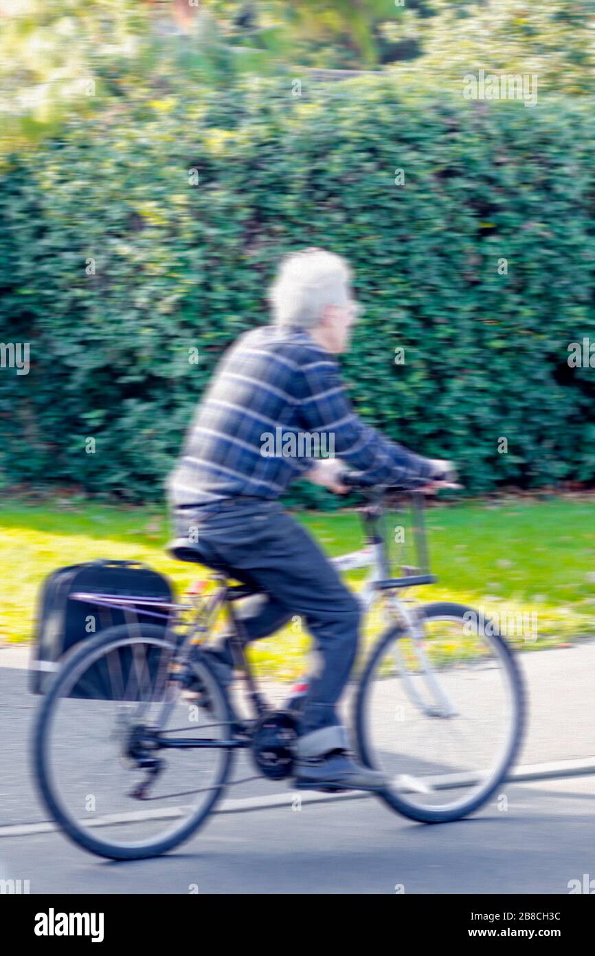 Abstract of retire man ride bike in the village Stock Photo - Alamy