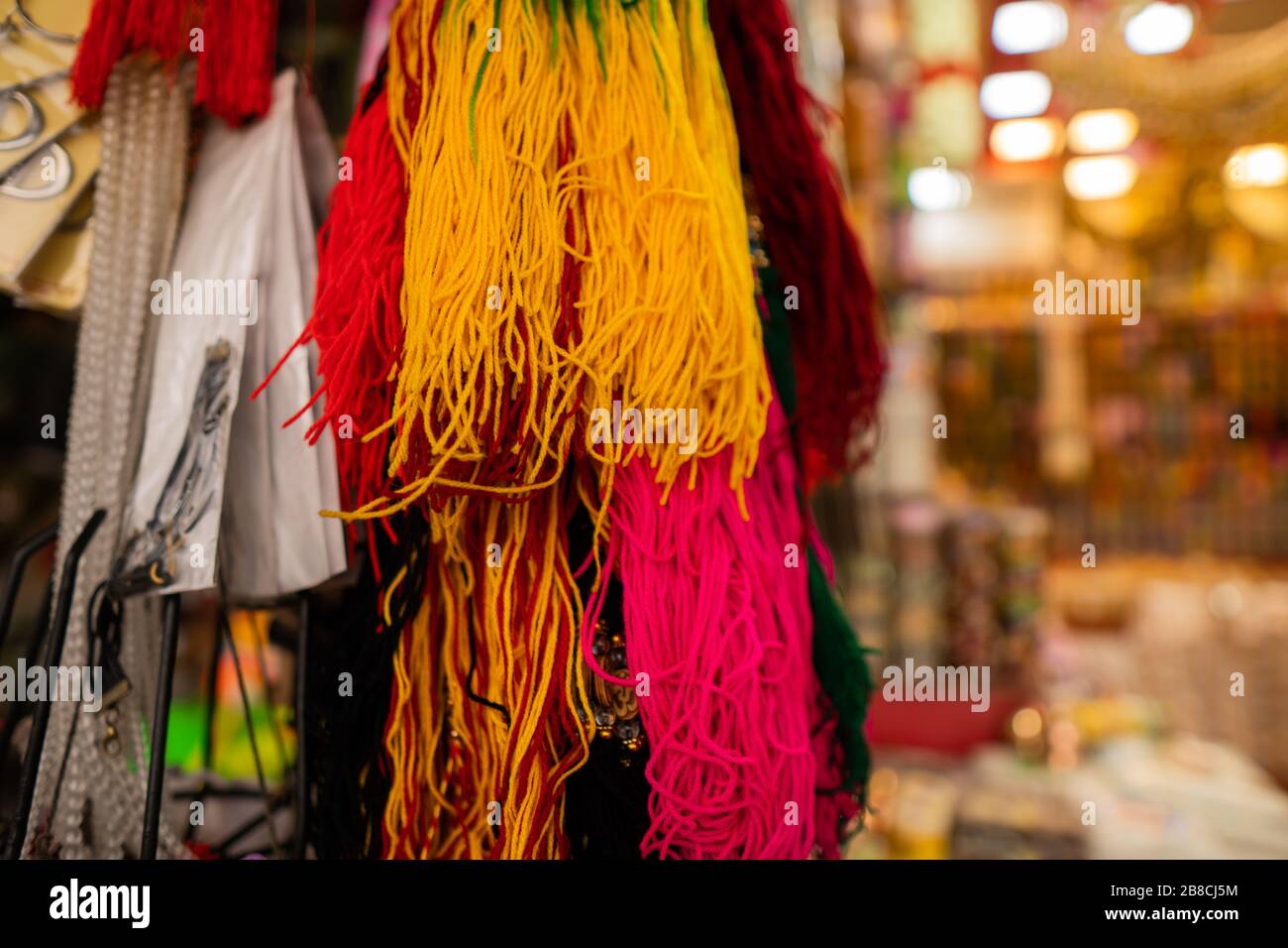 Different Color threads of Gods in a shop Stock Photo - Alamy