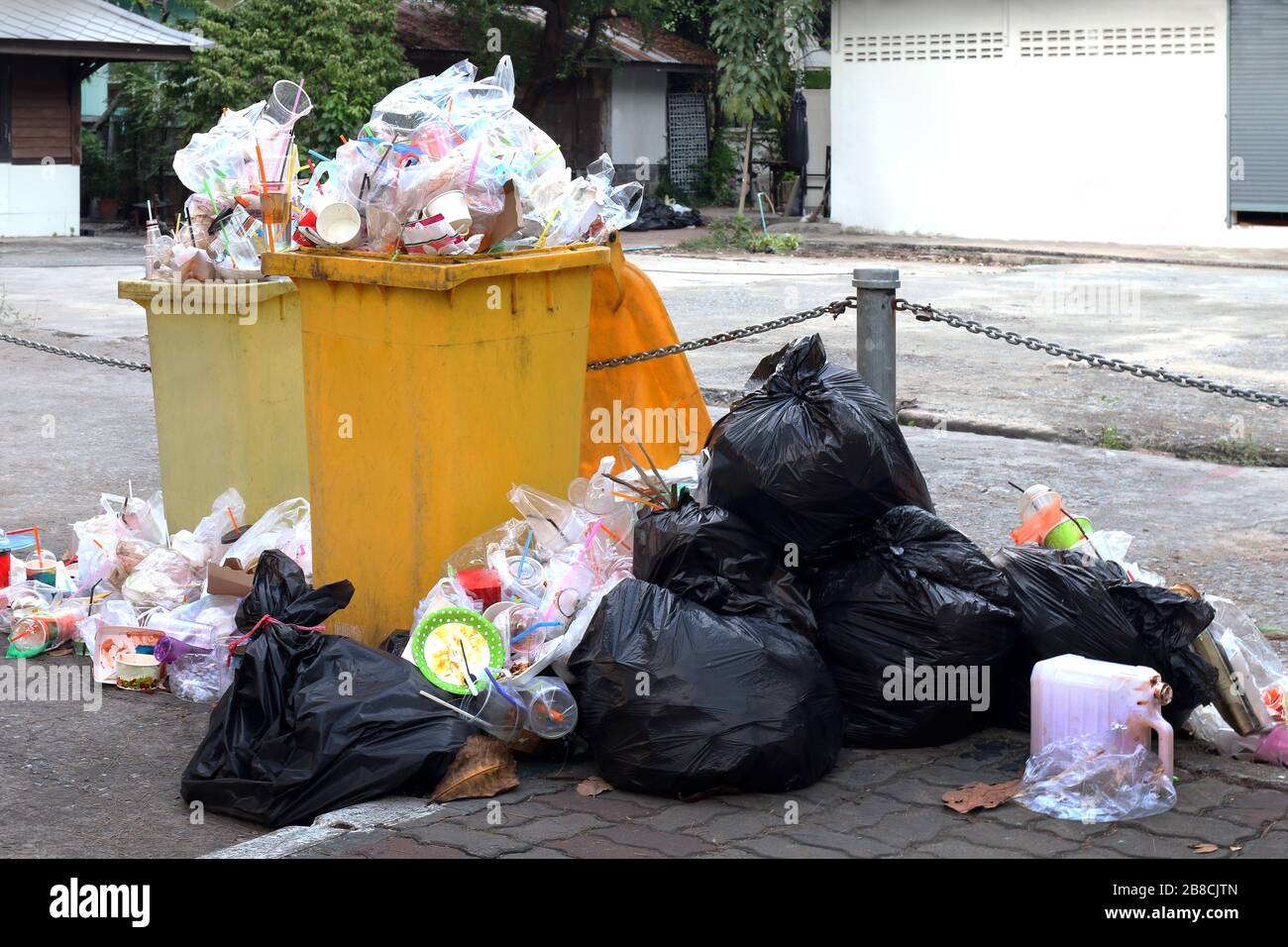 Pile of Garbage plastic black and trash bag waste many on the footpath ...
