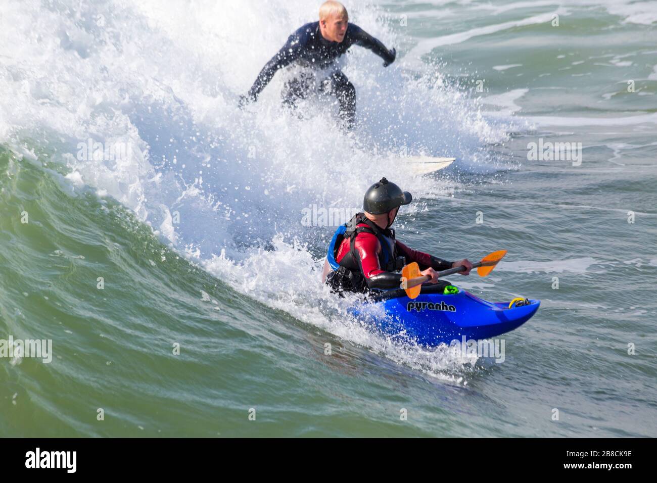 Bournemouth, Dorset UK. 21st March 2020. UK weather: kayaker makes the ...