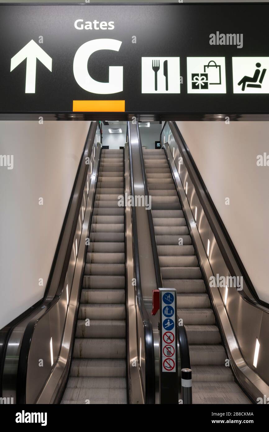 Sign showing gate locations and escalators to departure gates at ...