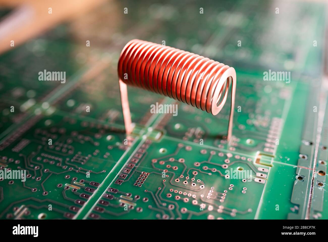 Twisted copper wire lies on a green chip. Computer hardware concept ...