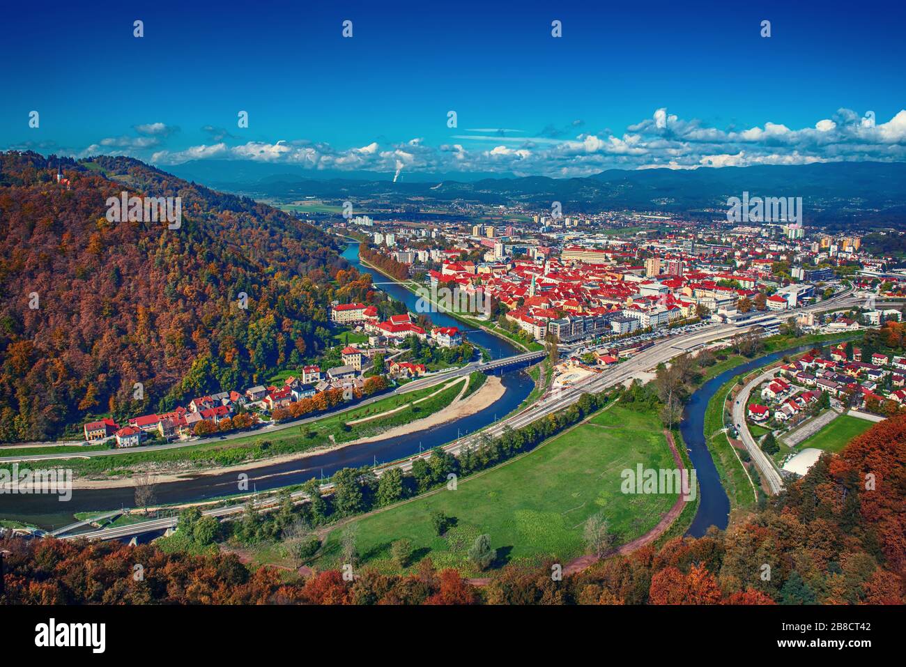 Aerial view to the city Celje in Slovenia. Autumn trees, green meadows ...