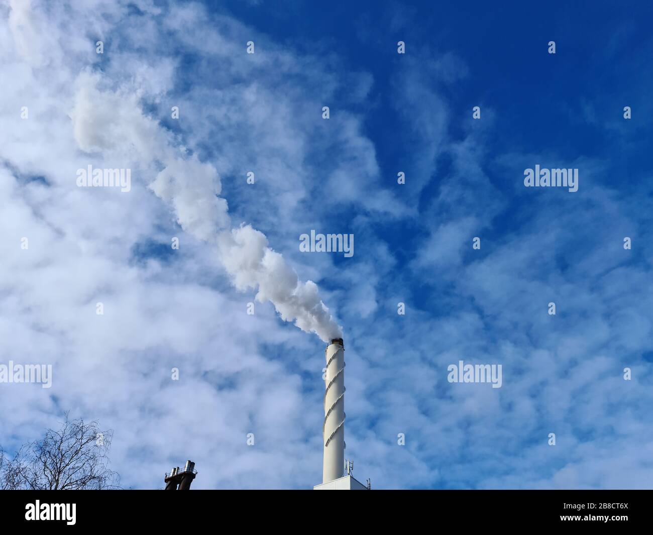View of white smoke from chimney on blue sky background. Ecology and ...