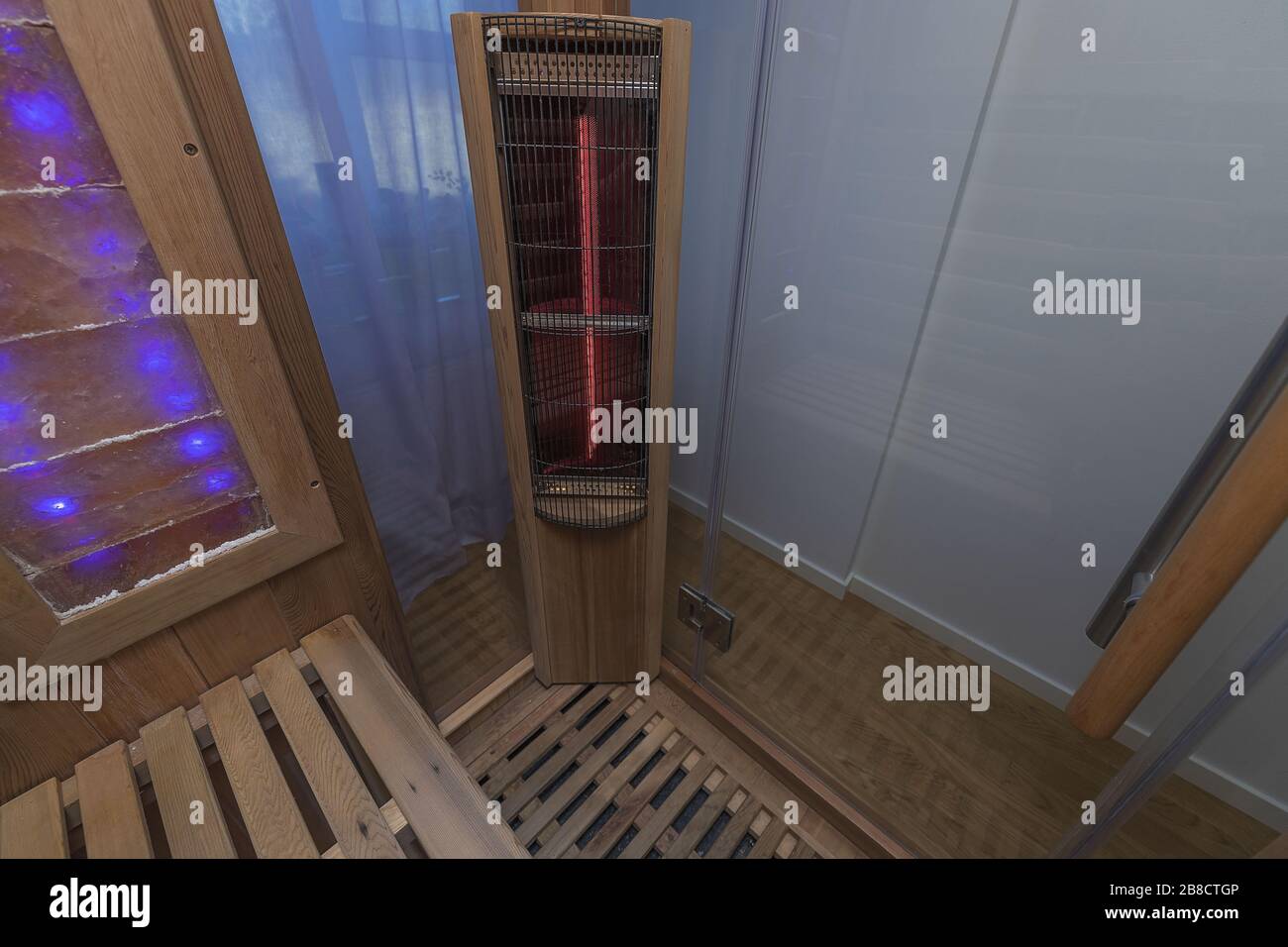 Infrared sauna interior close up view. Wooden walls and bench, ceramic ...