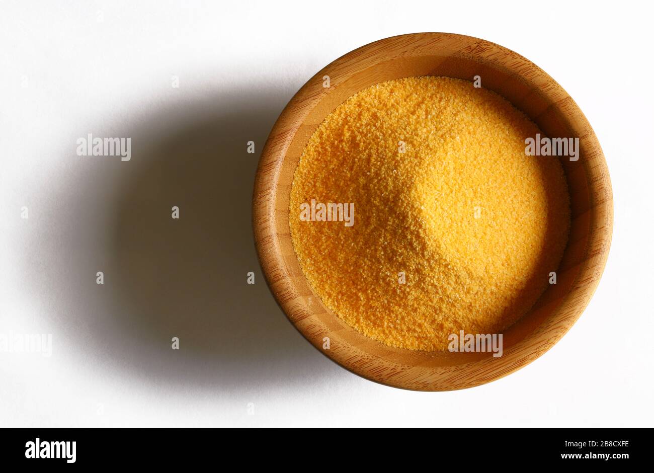 Maize flour in a wooden bowl isolated on white background. Top view ...