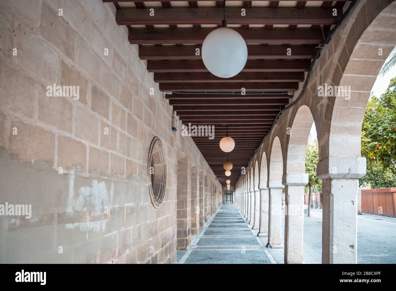A Beautiful Perspective of an Aisle with Brick Walls on the left ...