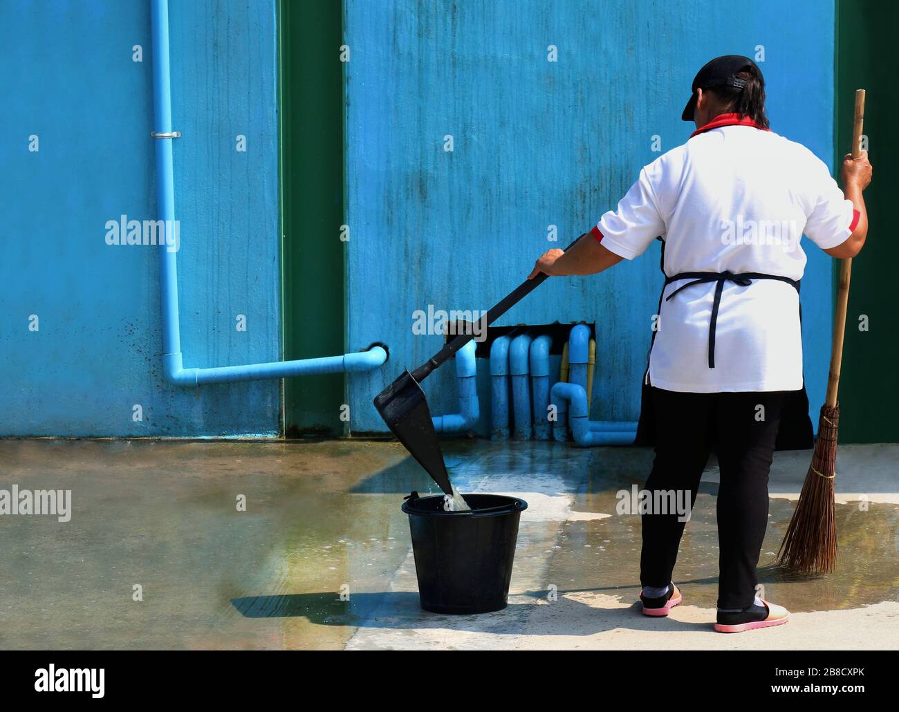 people are sweeping dirty water at ground streets, cleaner floor ...