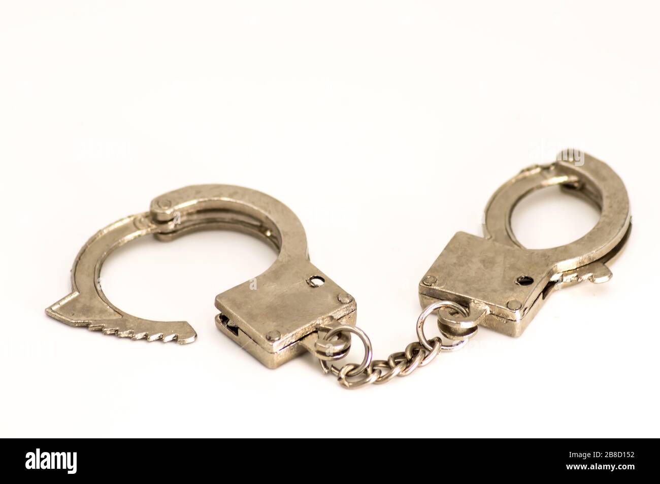 Pair of handcuffs close up front view on a white background Stock Photo ...
