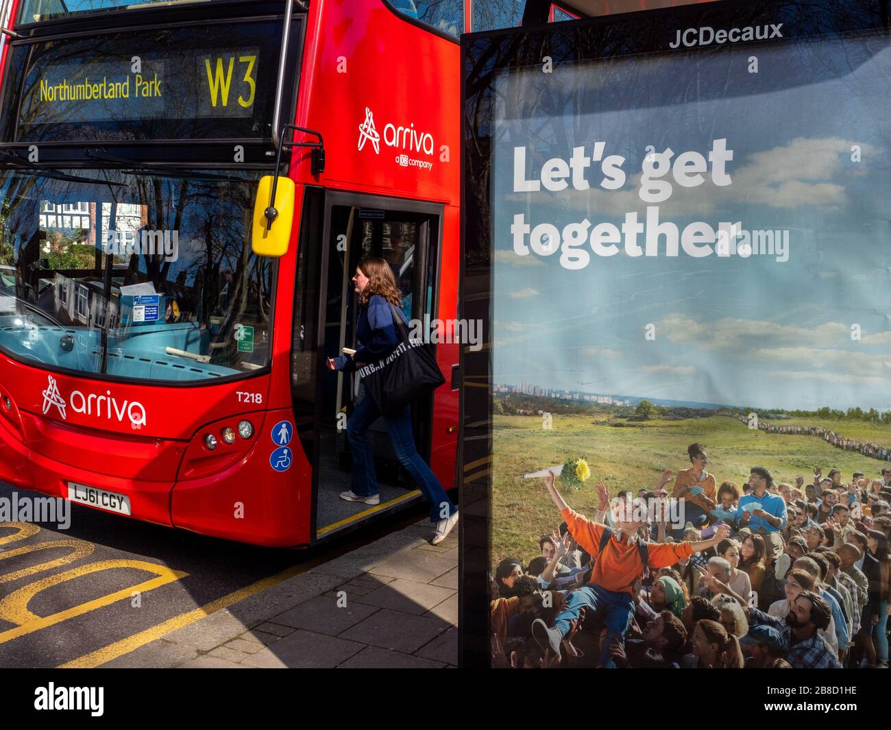 A woman steps on board a red London bus Stock Photo - Alamy
