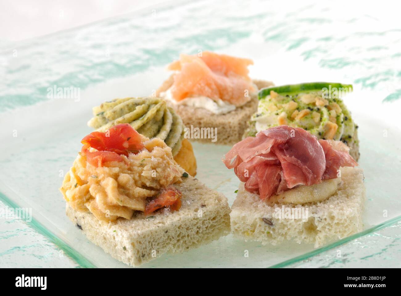 Assortment of various appetizer canapes on plate Stock Photo - Alamy