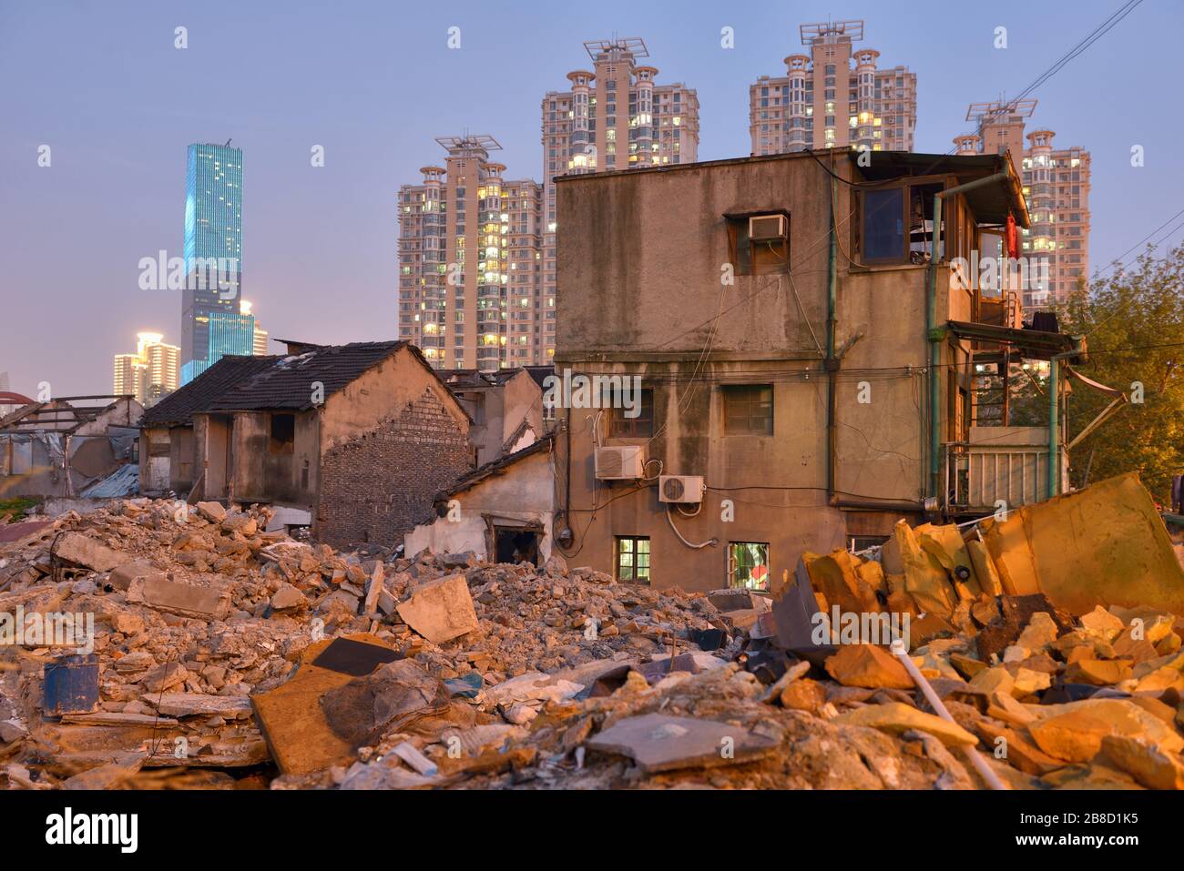 Old ruin house with people still living in, modern buildings in ...