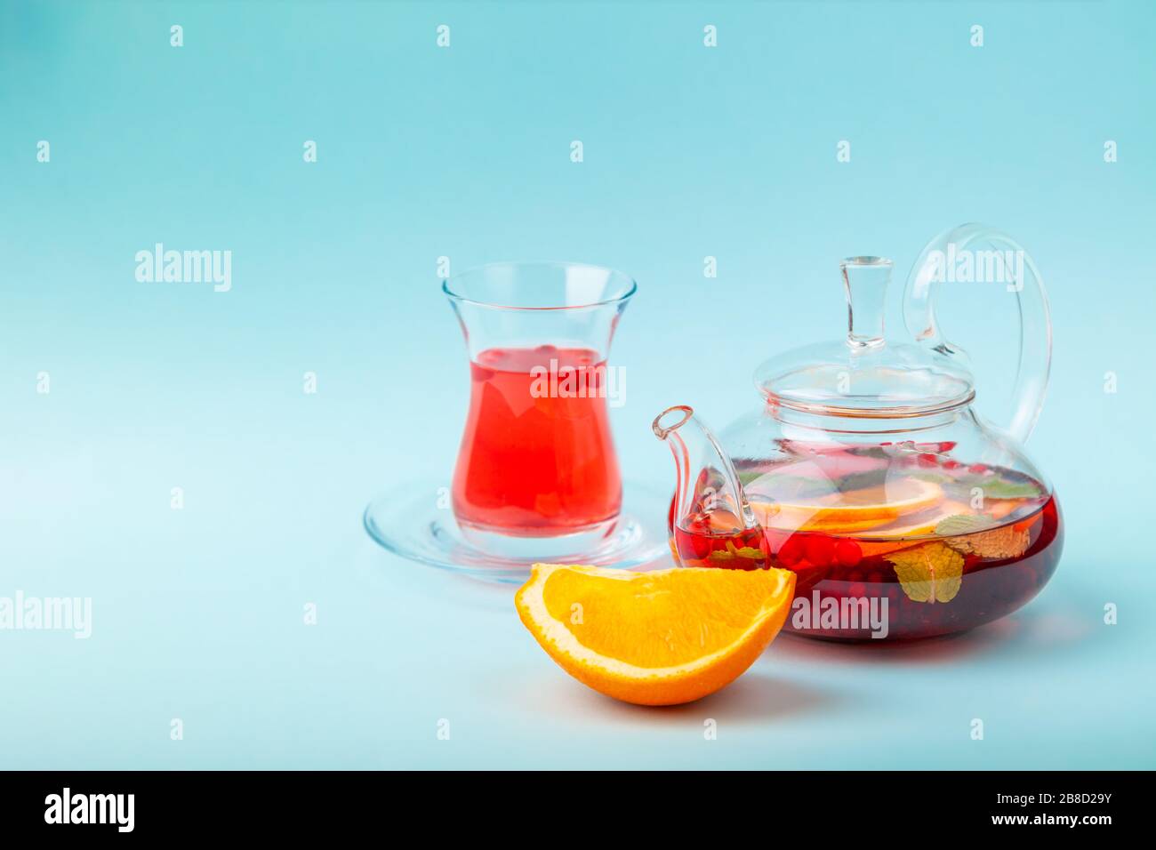 Fruit tea with berries in kettle, turkish shape tea cup Stock Photo - Alamy