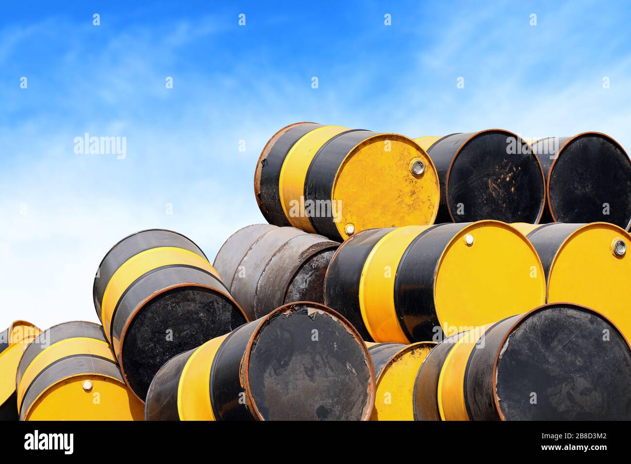 barrel oil, pile of old barrel oil gas tank metal on sky blue Stock ...
