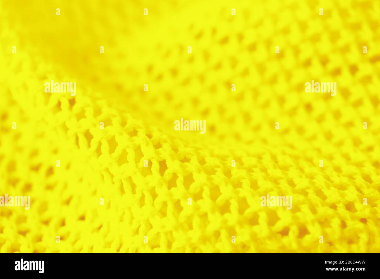 Vivid yellow fabric mesh textile background, knitting background ...